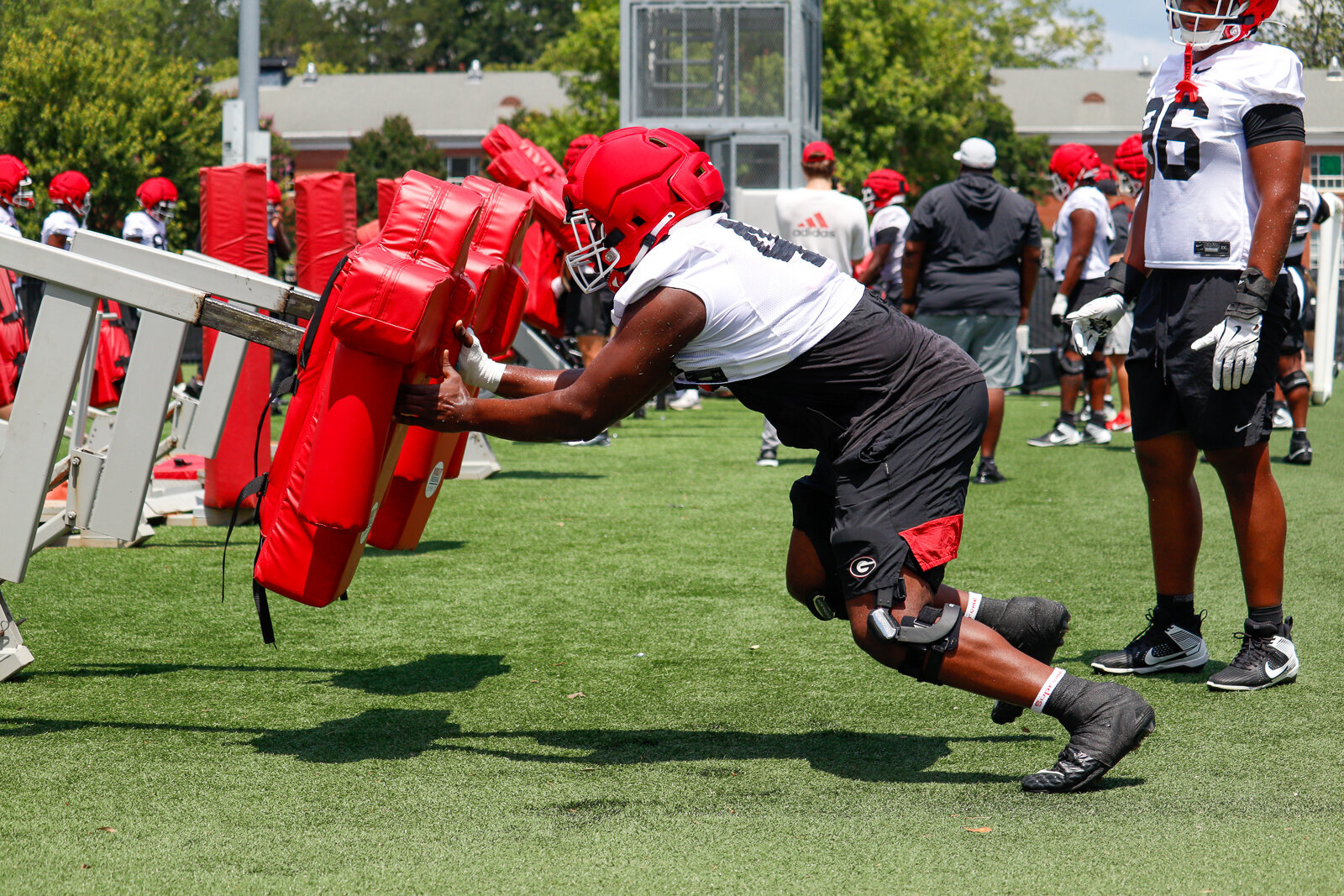 DL #44 Jordan Hall works against a sled as #96 JJ Hanne looks on - Fall ...