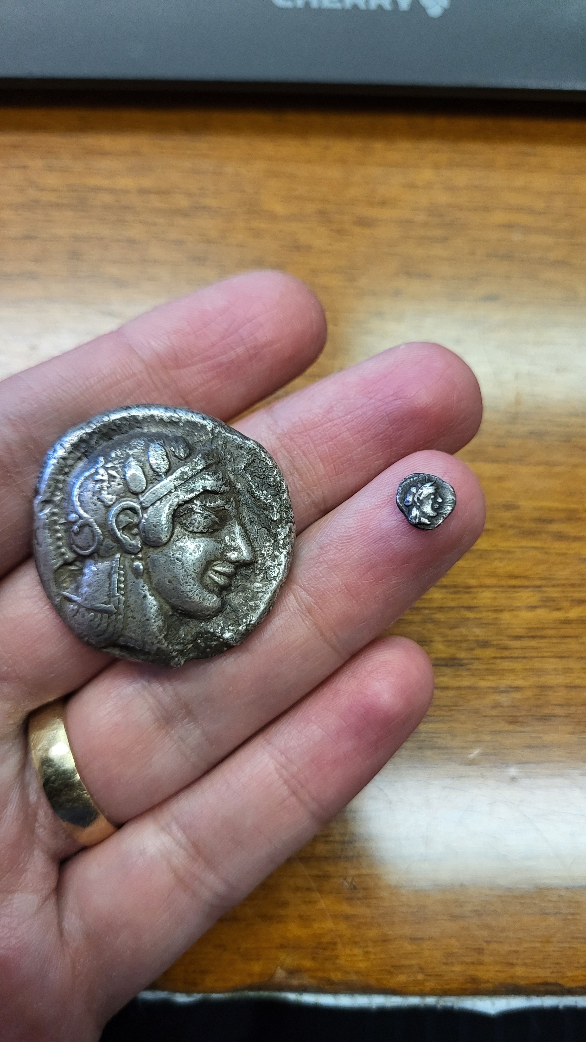 A very large and a very small silver coin from Athens (from the ...