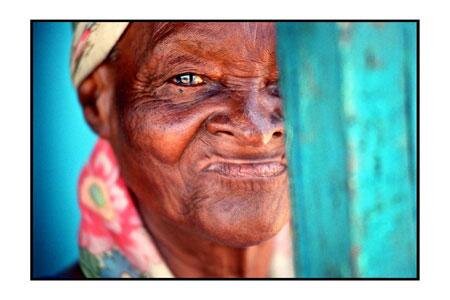 A woman peers from a shanty built at the garbage dump on the outskirts ...