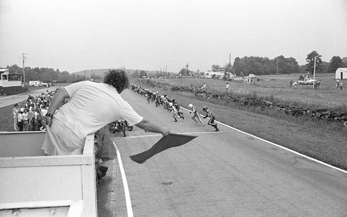 A flagger starts the 1980 24-Hours of Nelson motorcycle road race in ...