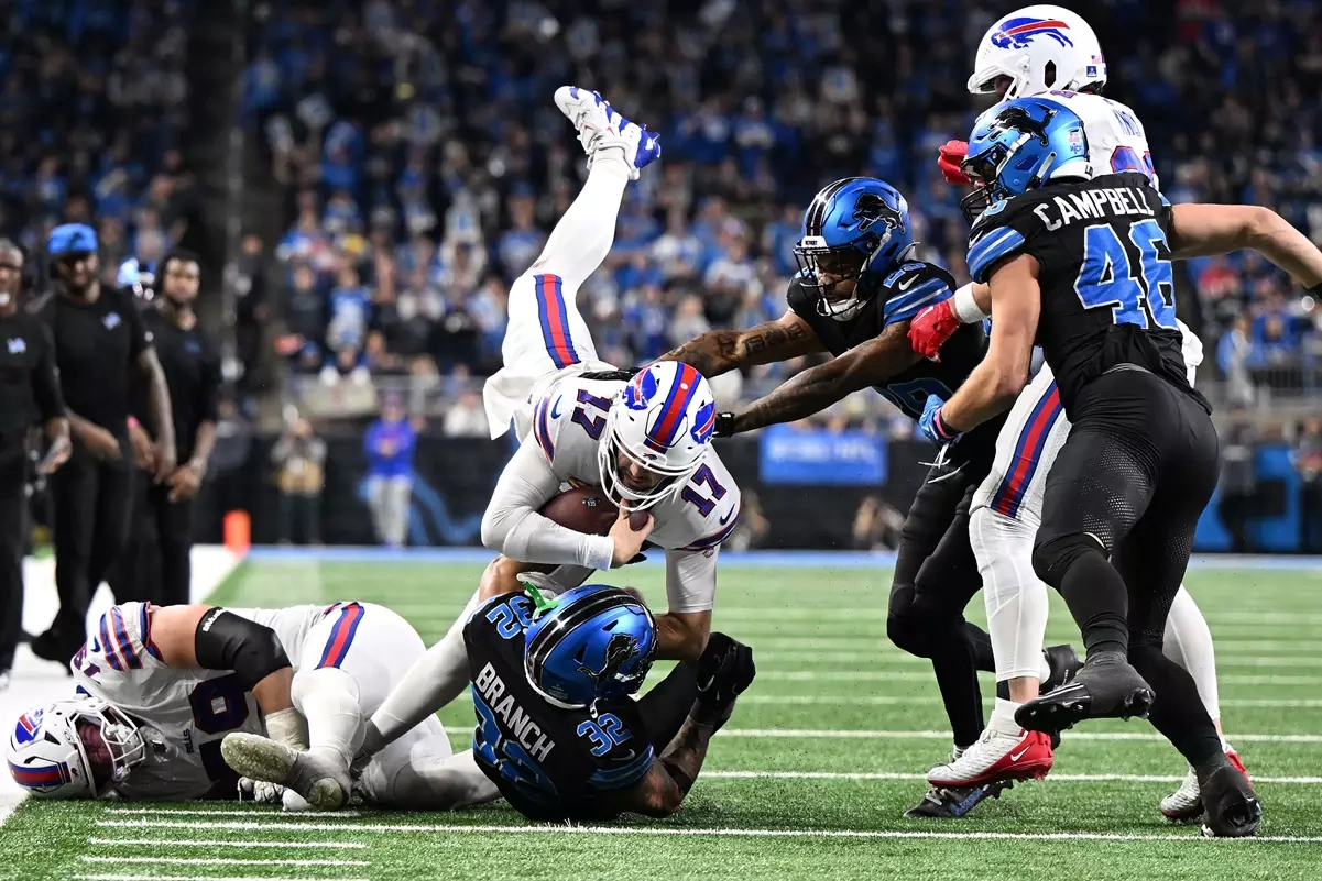 An airborne Josh Allen dives for a first down and then body surfs over ...